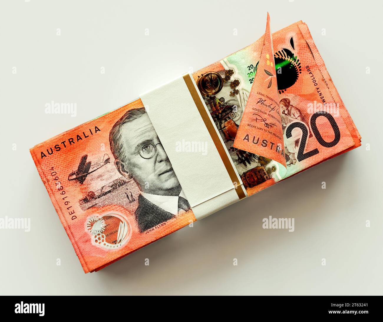 A bundled wad of Australlia Dollar banknotes on an isolated light ...