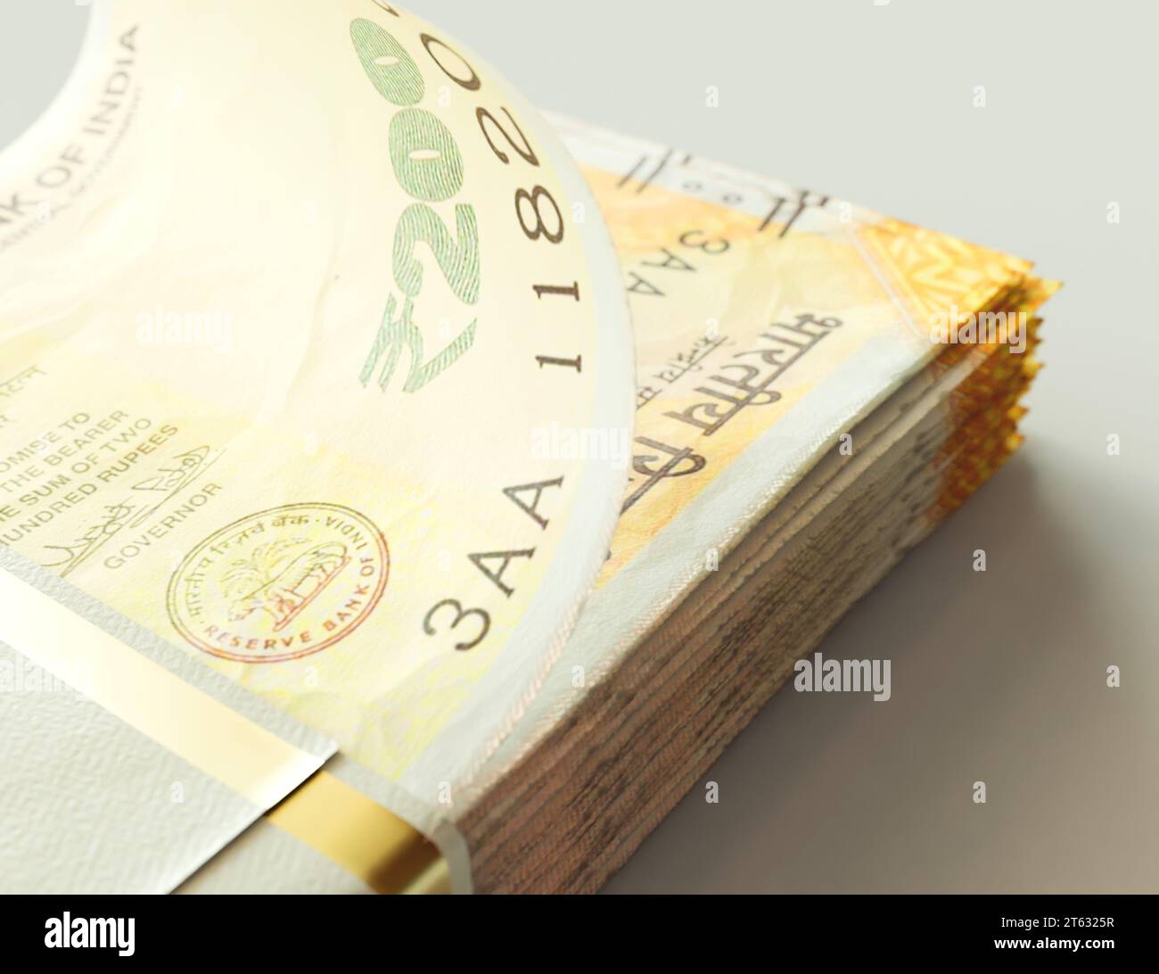A bundled wad of India Rupee banknotes on an isolated light background ...