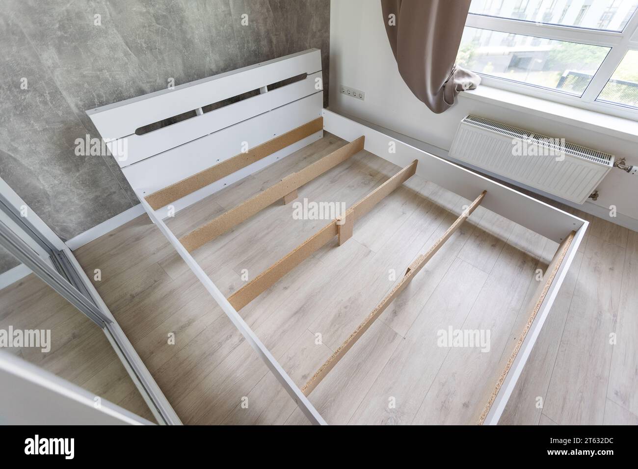 The furniture assembler assembles the bed frame, do it yourself and ...