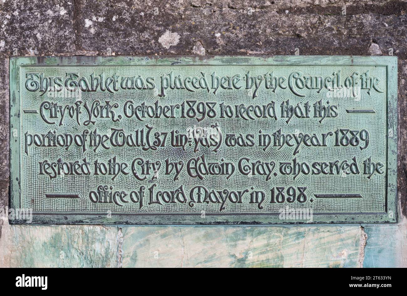 Bronze plaque on York city walls recording the restoration of a section ...