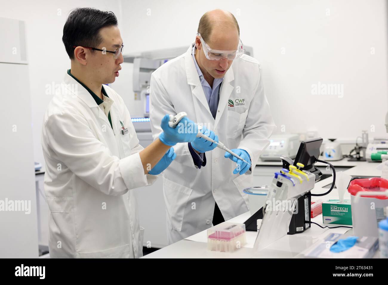 The Prince of Wales wears a lab coat and uses forensic equipment as he ...