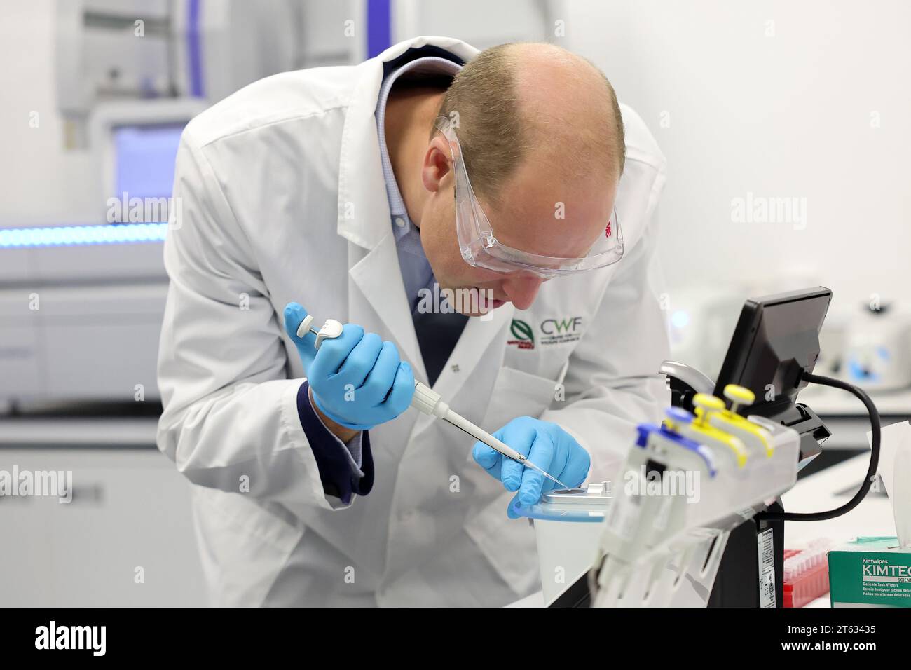 The Prince of Wales wears a lab coat and uses forensic equipment as he ...
