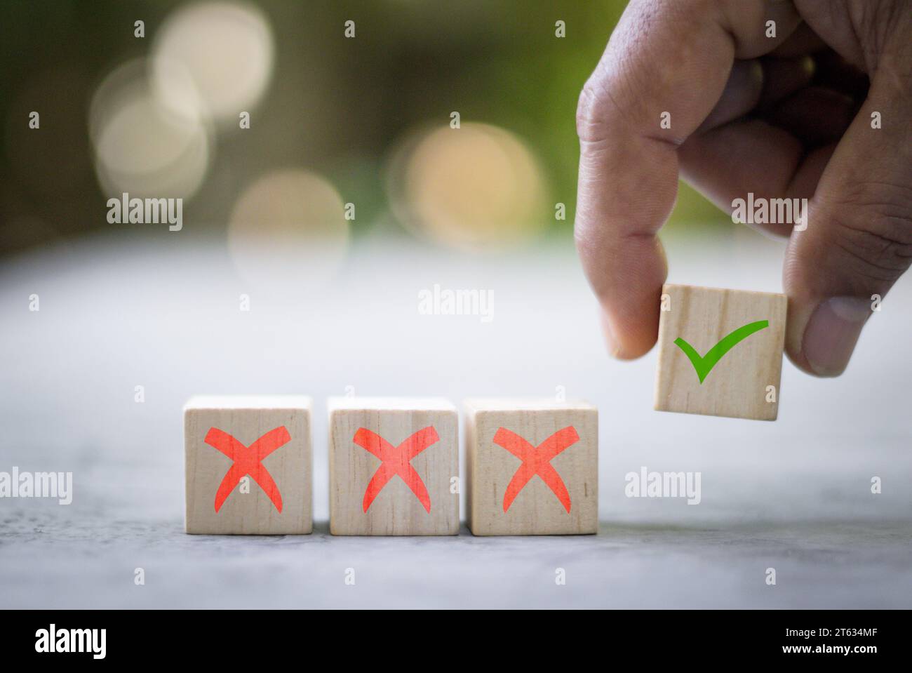 Wooden blocks checklist and green check mark icon with hand on table ...
