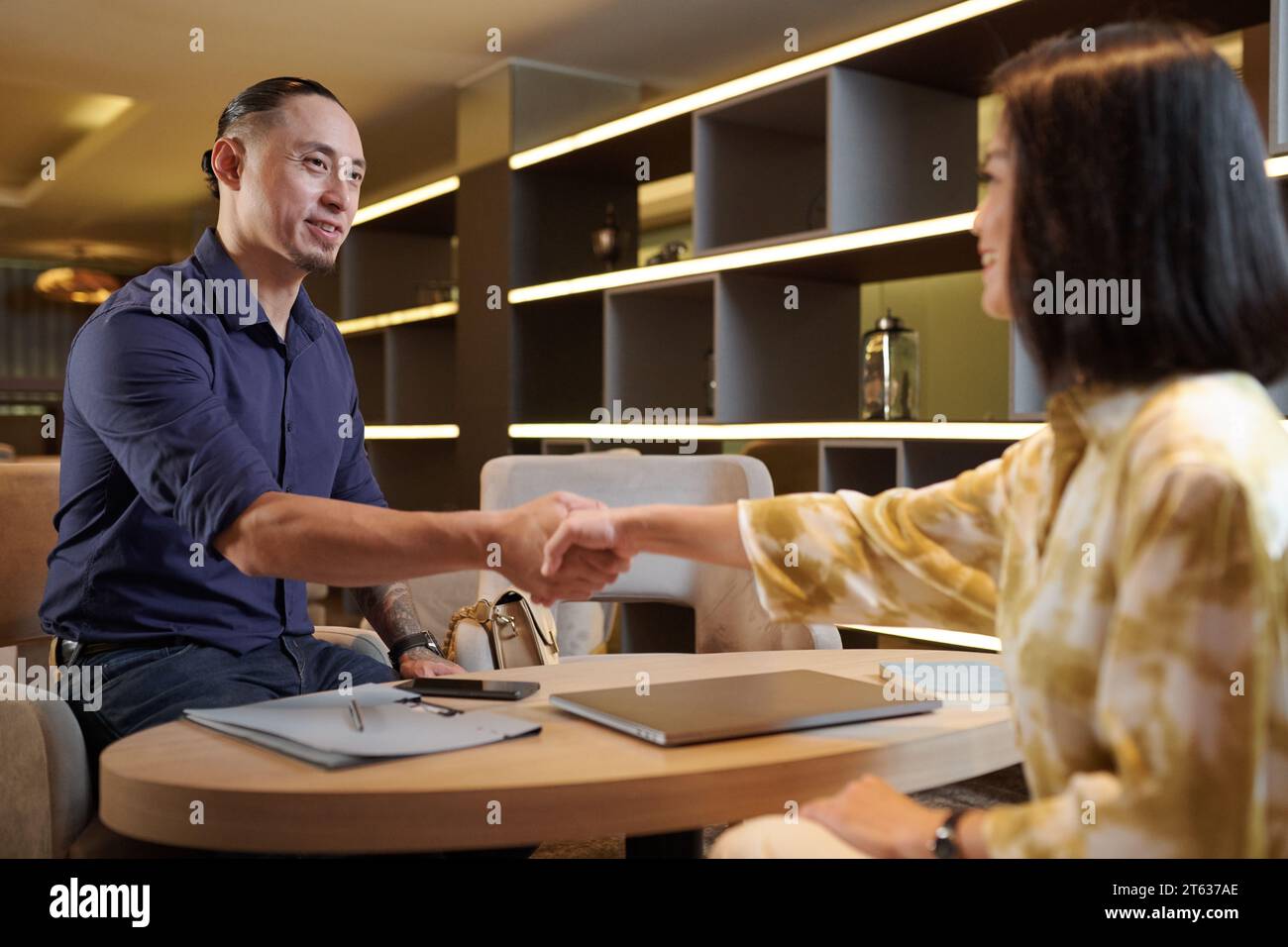 Project founder meeting with investor in office lounge area Stock Photo ...