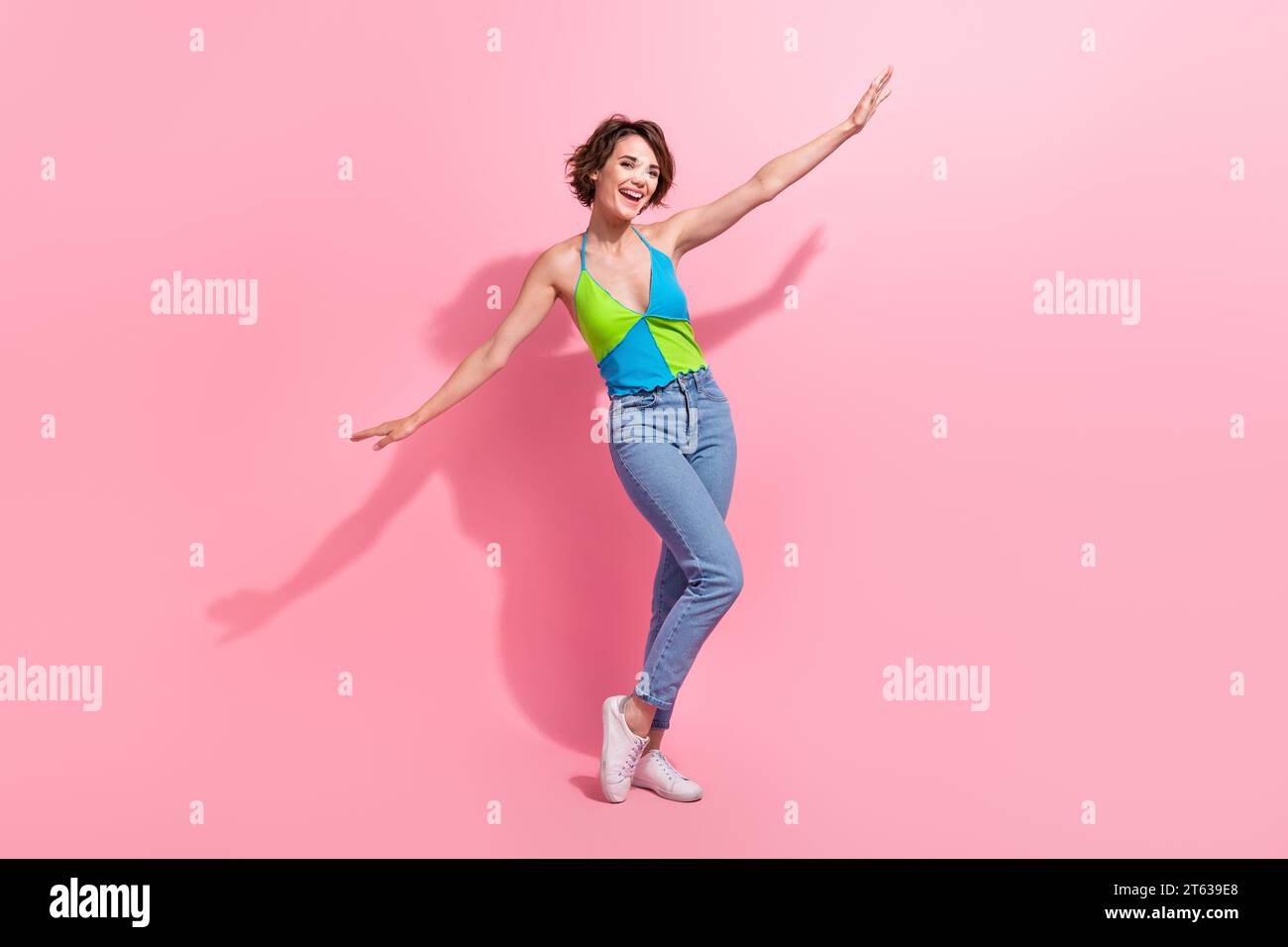 Full body cadre of funky girl look like she flying airplane hands wear ...