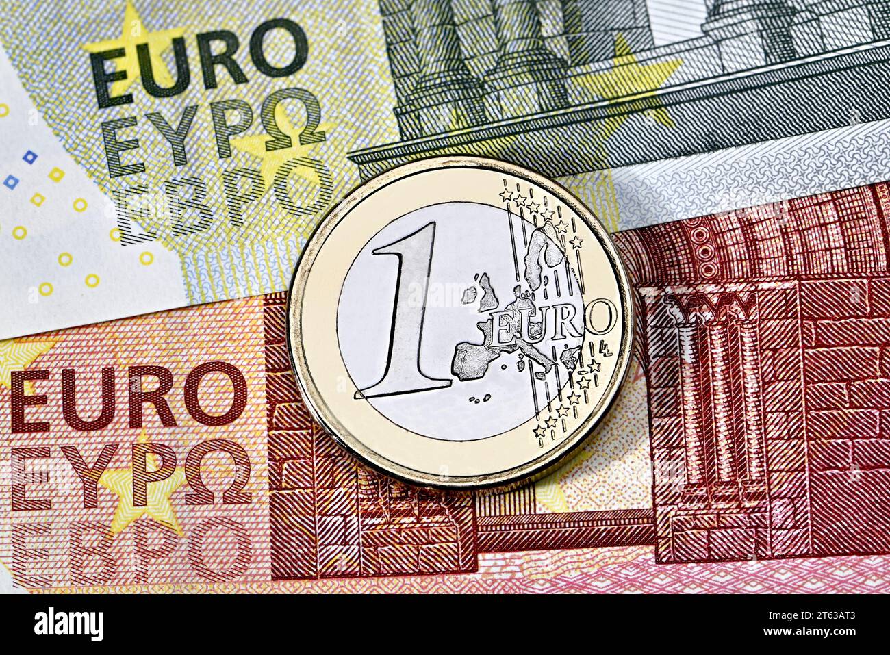 1 Euro coin on €5 and €10 notes Stock Photo - Alamy