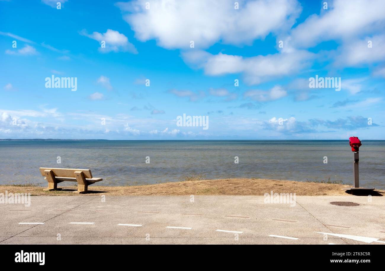 Scenic sea view with bench and zoom binoculars. Blue ocean water and ...