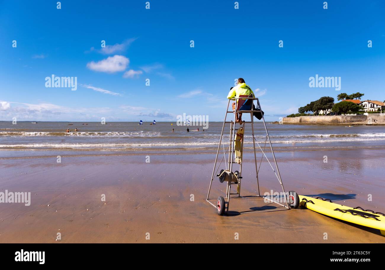 Rescuer person on beach and boat kayak next to man. Beautiful seaview ...