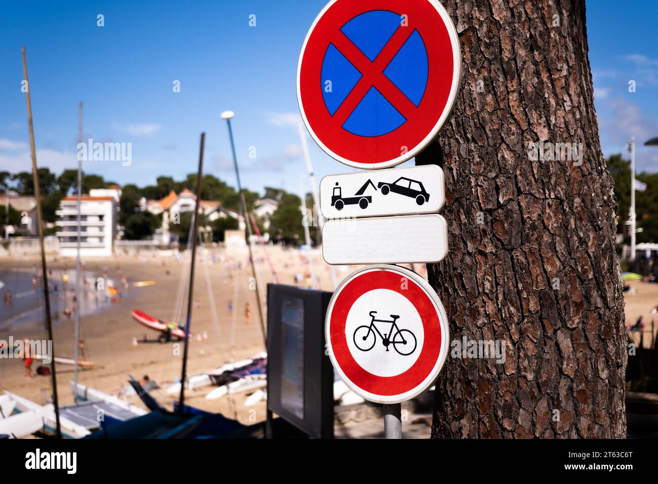 Warning sign with bicycle and cars on beach with sea shore view. Bike ...