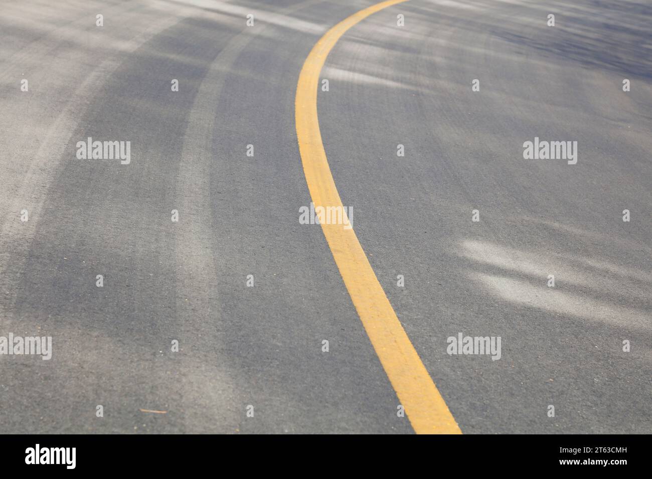 yellow lines on the road Stock Photo - Alamy