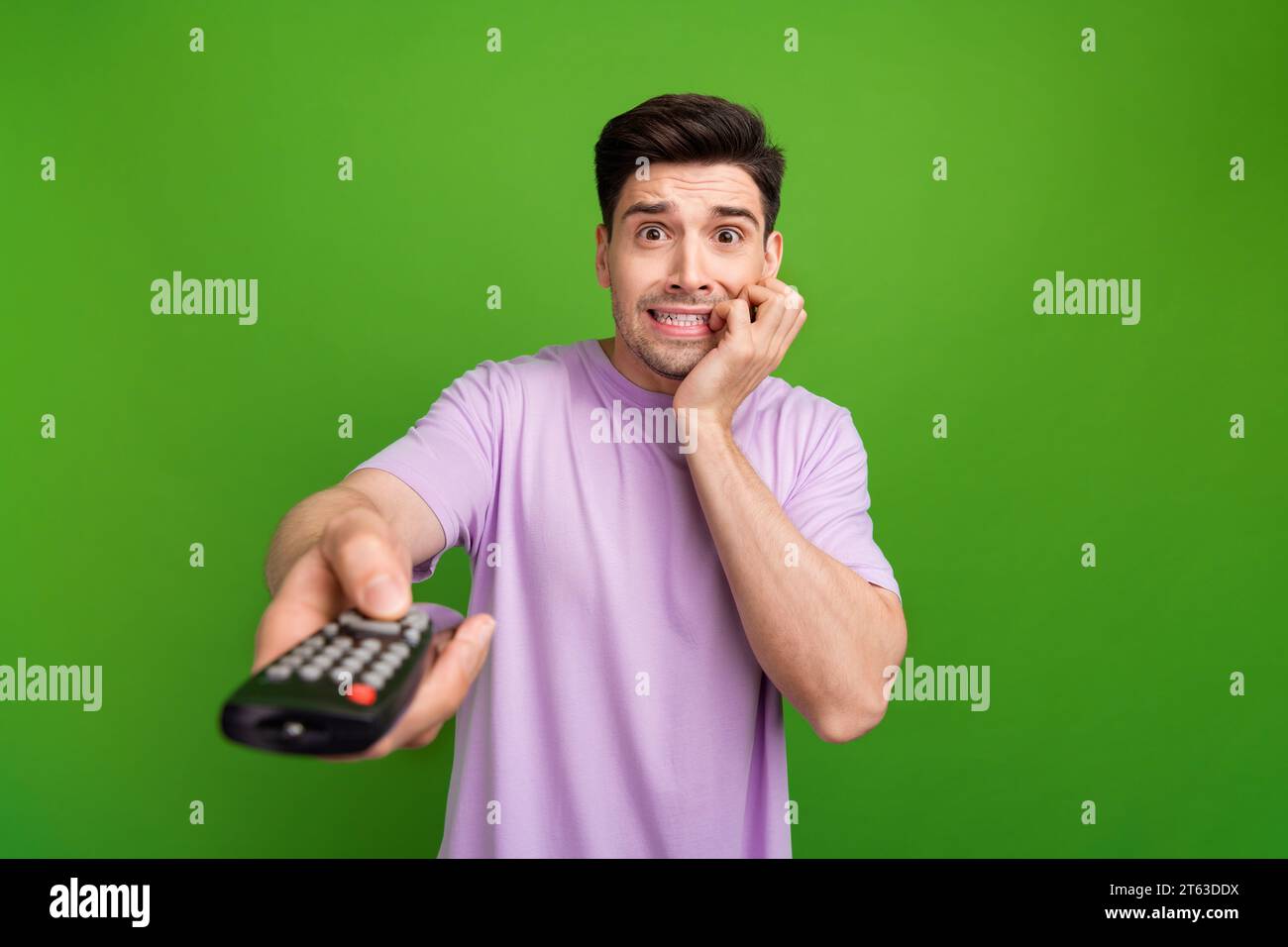 Photo of frightened man with brunet hair dressed t-shirt hold remote ...