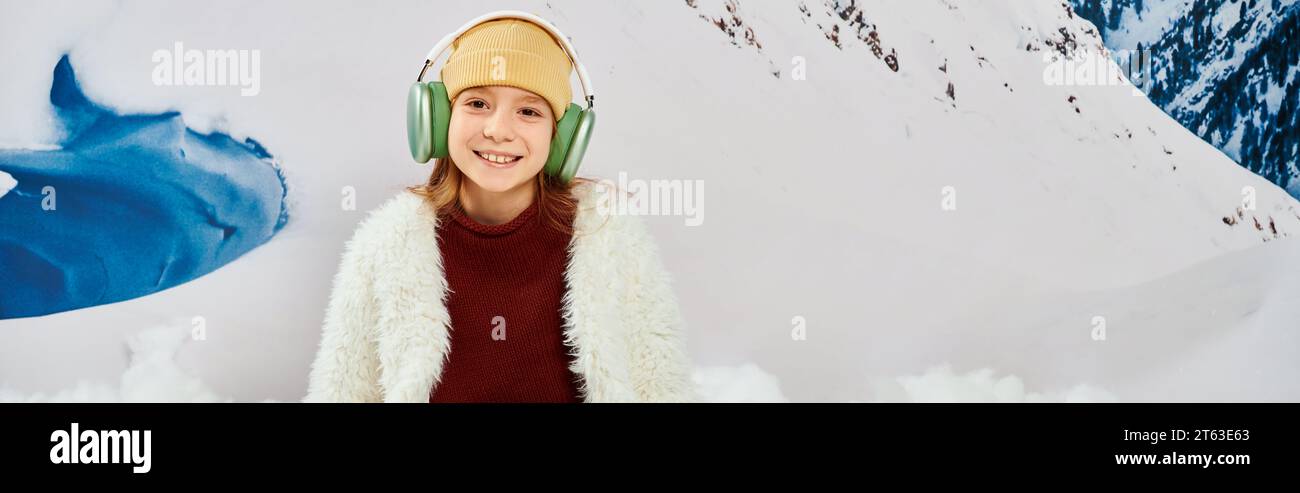 jolly preteen girl in stylish attire with headset smiling happily at ...
