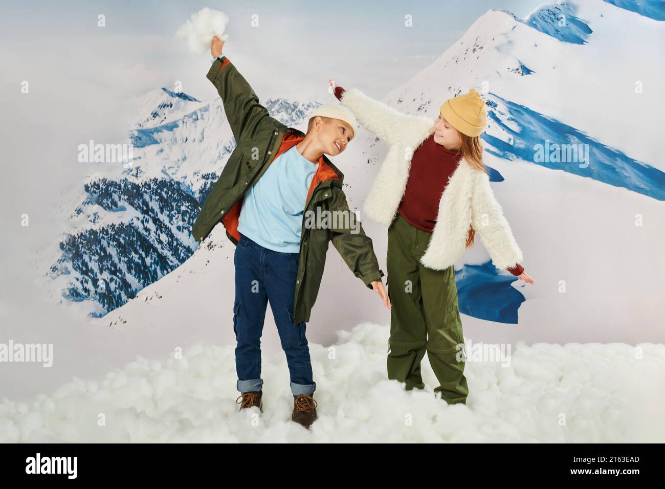 stylish friends in warm attire posing in motion, holding hands like a ...