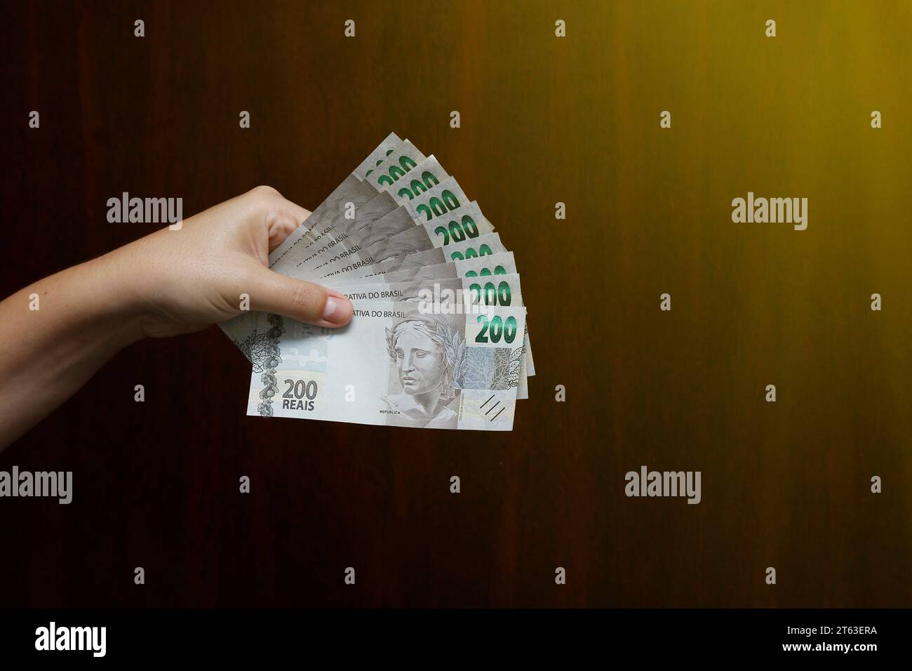 Hands holding Brazilian real notes, Brazil BRL banknote, Brazilian ...