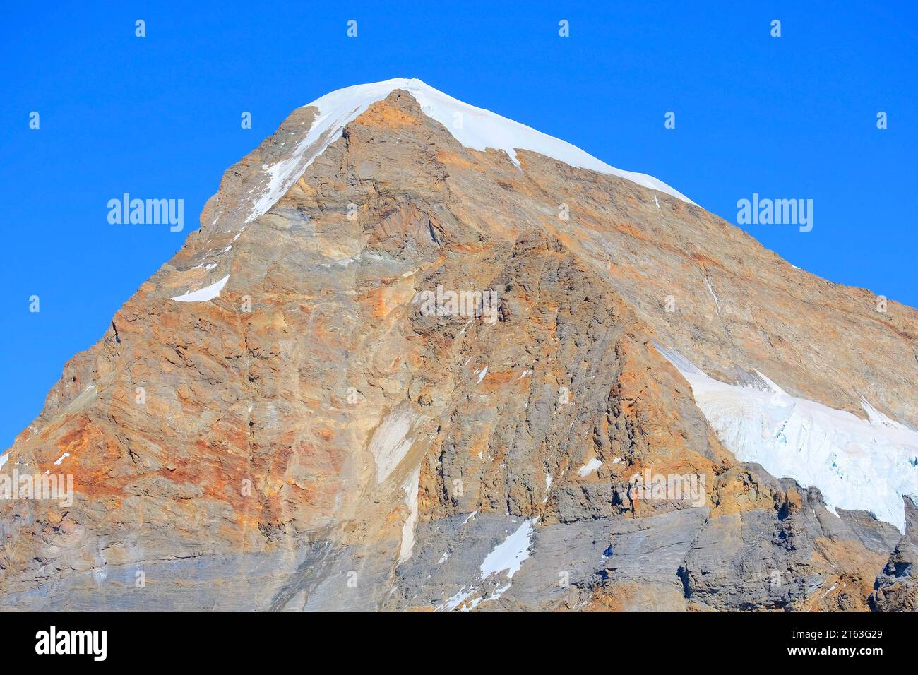 Brown and gray colored mountain with snow on summit heads toward the ...