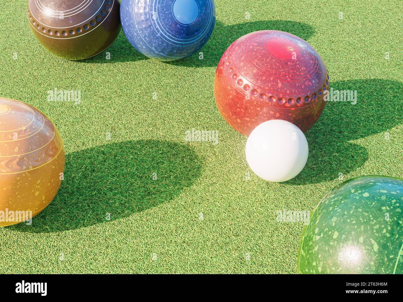 A set of colorful modern wooden lawn bowls next to a jack on a perfect ...