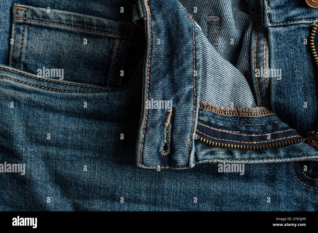 A detailed shot capturing the pocket and stitching details of a blue ...