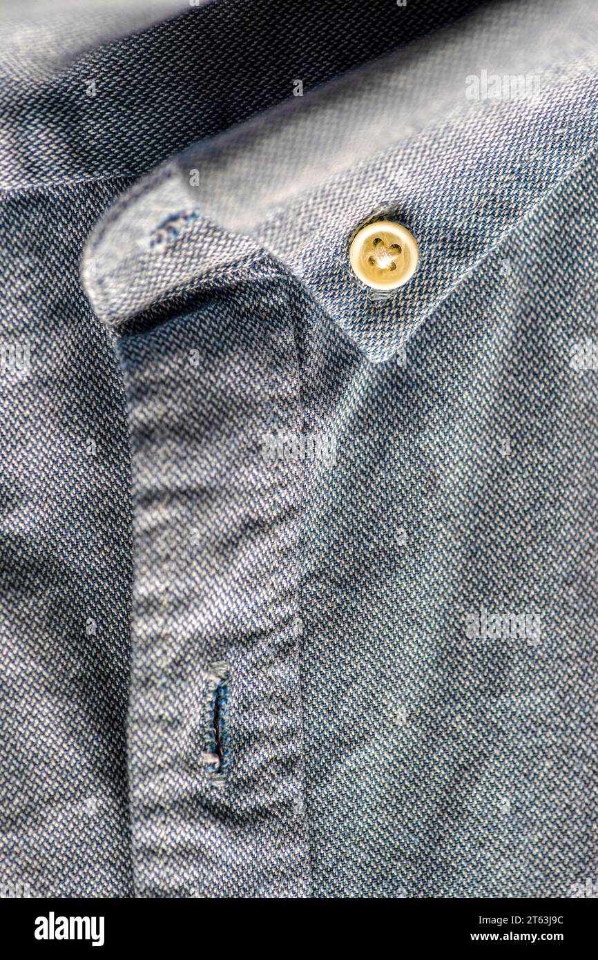 Close-up of a gray shirt's collar and button detailing, highlighting ...
