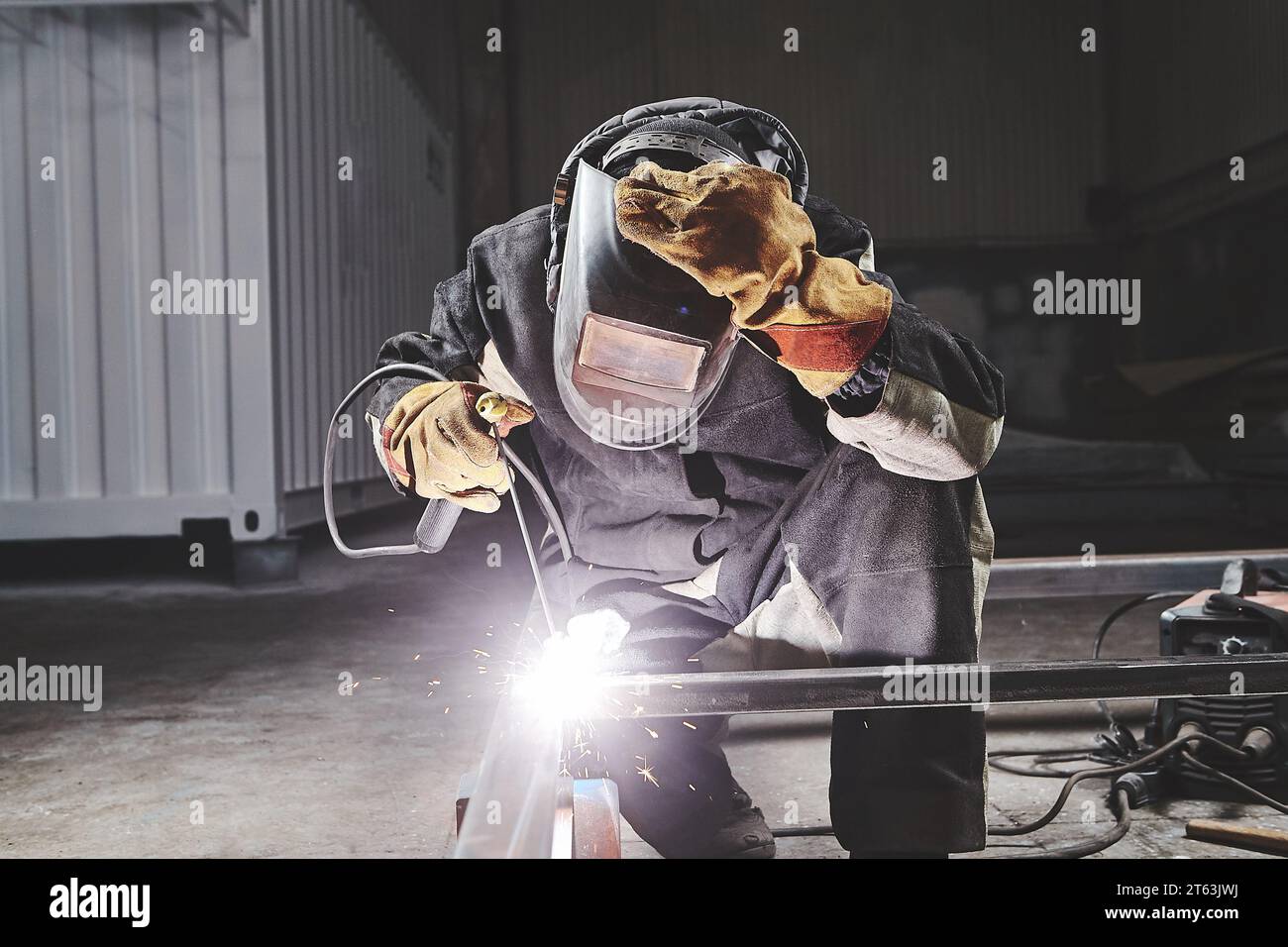 Industry worker welding iron pieces at the factory Stock Photo - Alamy