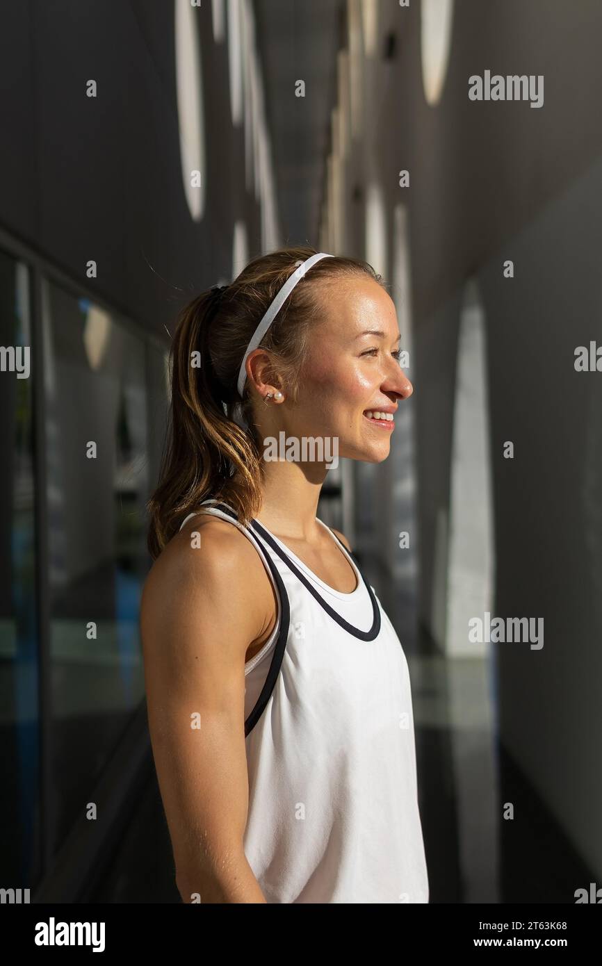 Photo of a Active Woman Captured in a White Tank Top Striking a Pose ...