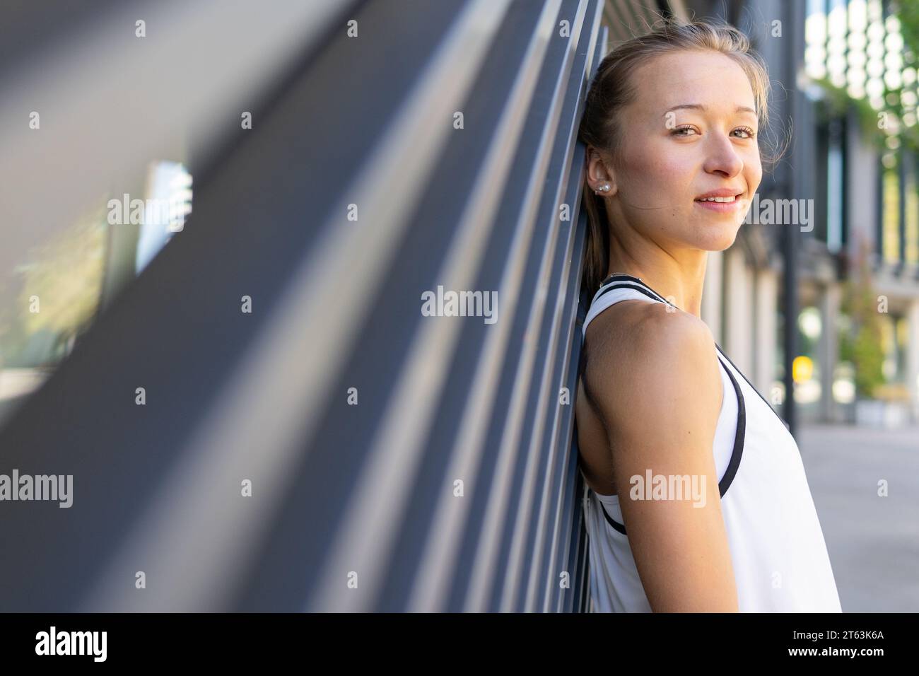 Photo of a Active Woman Captured in a White Tank Top Striking a Pose ...