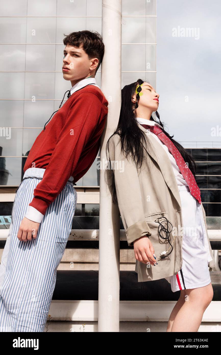Close-up view of young Gen-Z pair in trendy attire, posing confidently ...