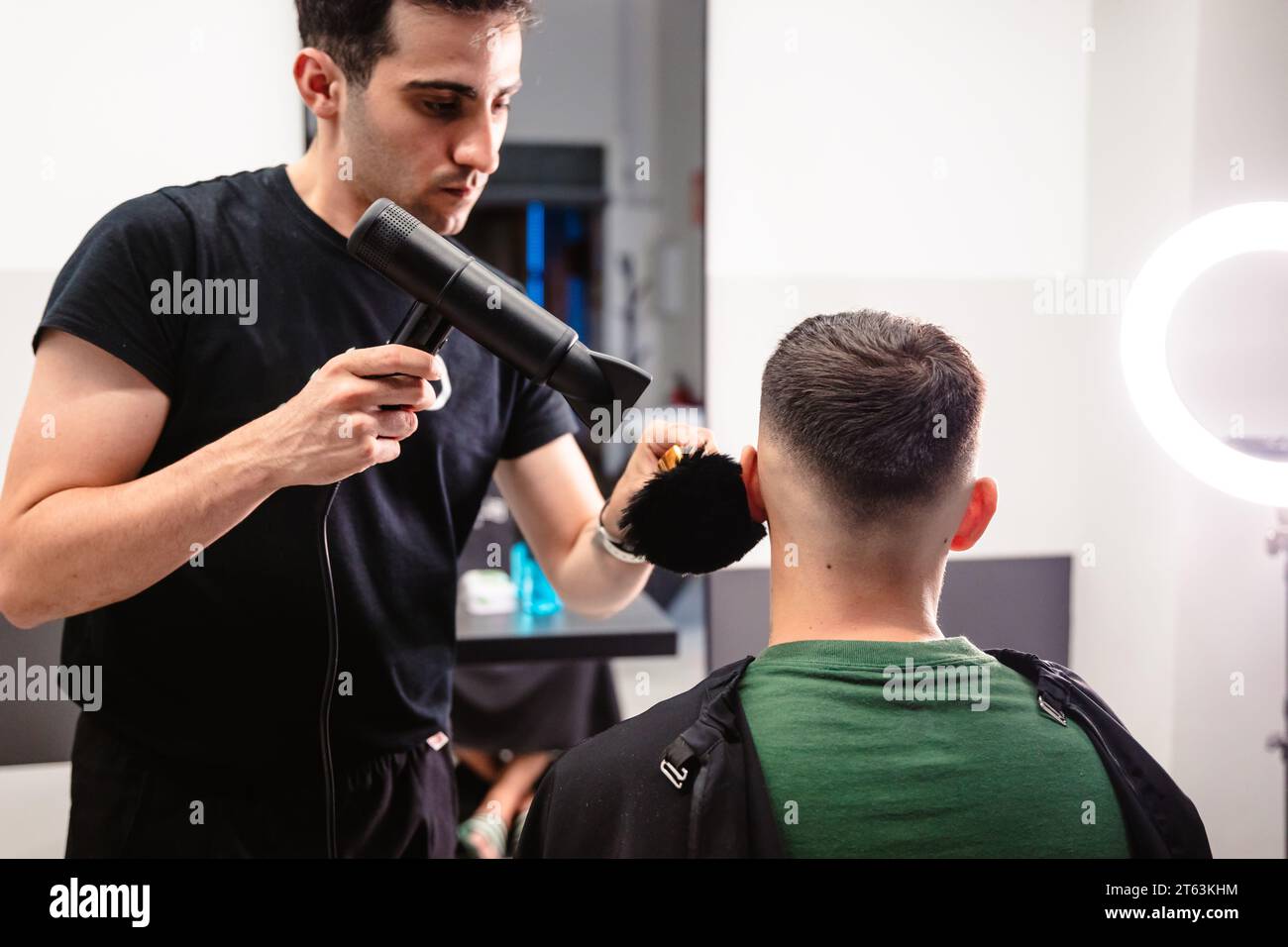 Professional barber using hair dryer hi-res stock photography and ...