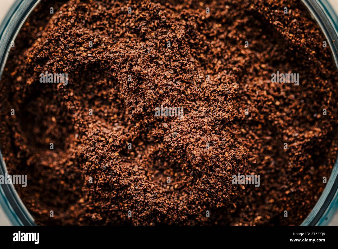 Top view of finely ground coffee filling a ribbed glass jar ...