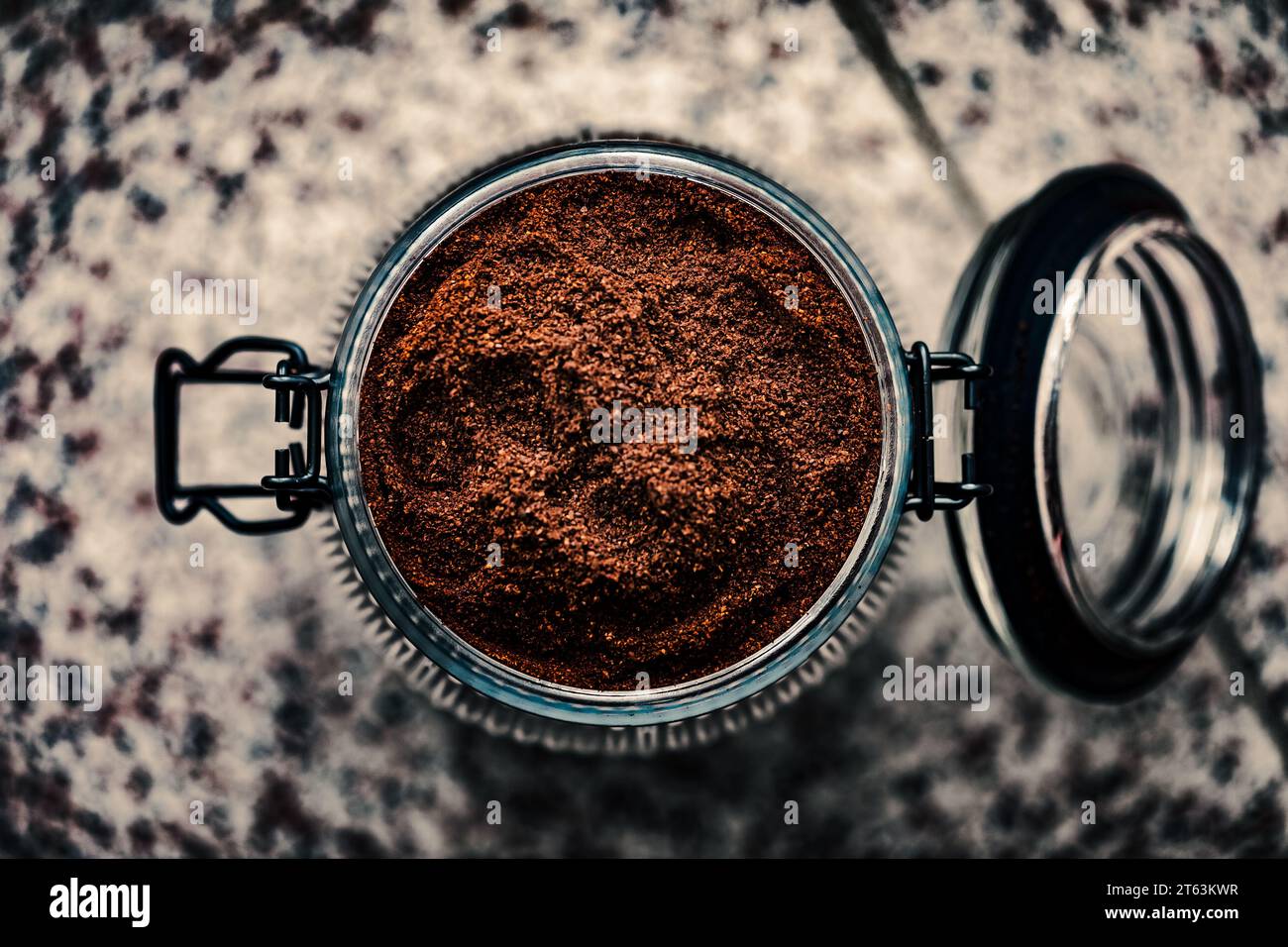Top view of finely ground coffee filling a ribbed glass jar ...