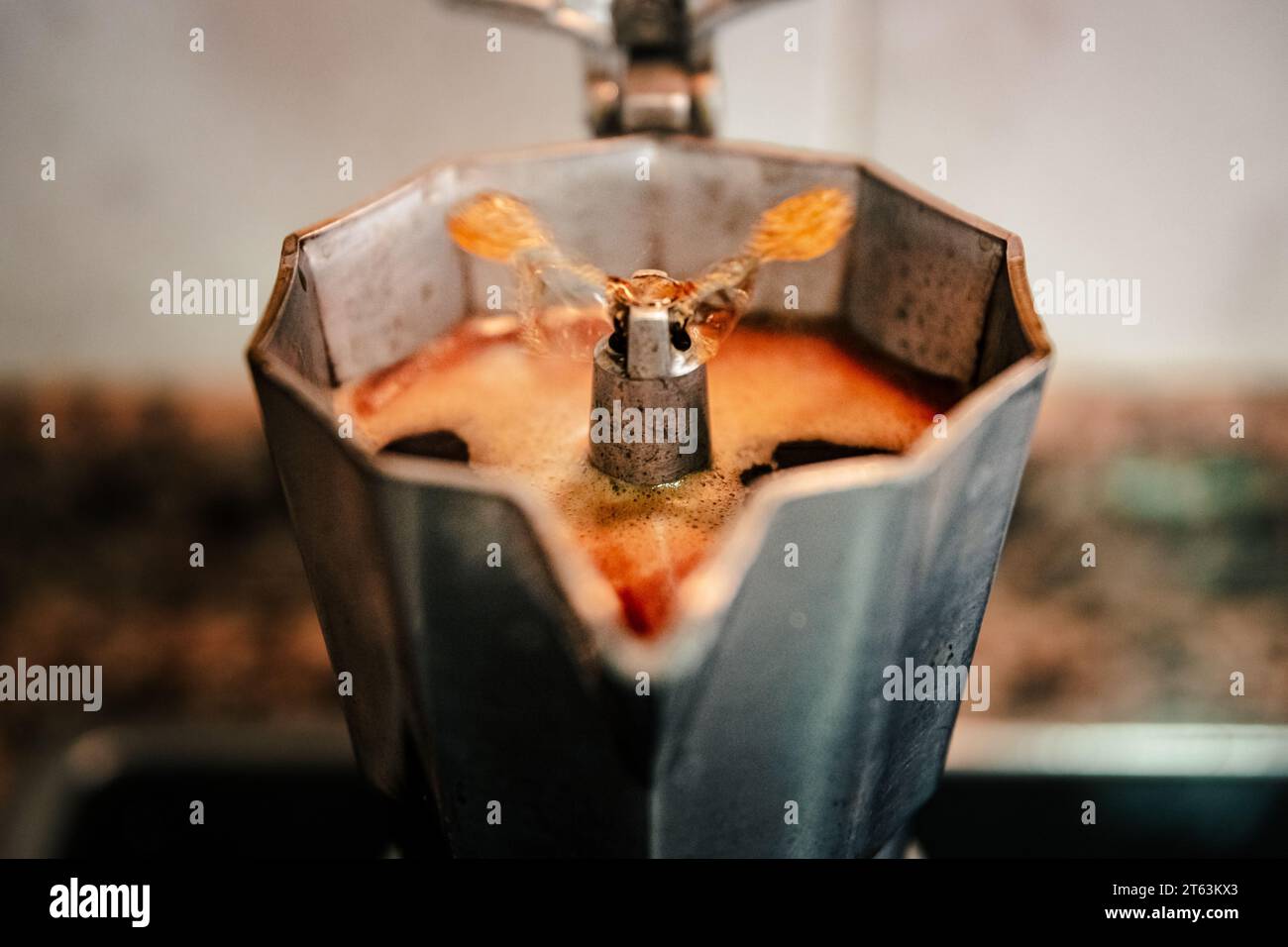 Close-up of bubbling coffee in an open stovetop espresso maker ...