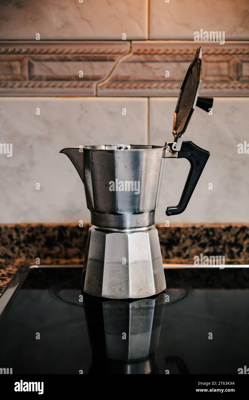 Close-up of stainless steel stovetop espresso maker placed on sleek ...