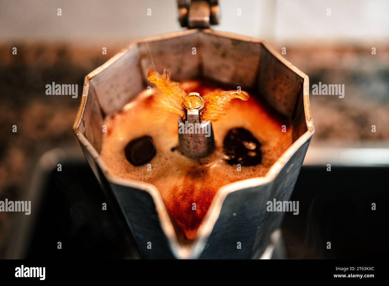 Close-up of bubbling coffee in an open stovetop espresso maker ...