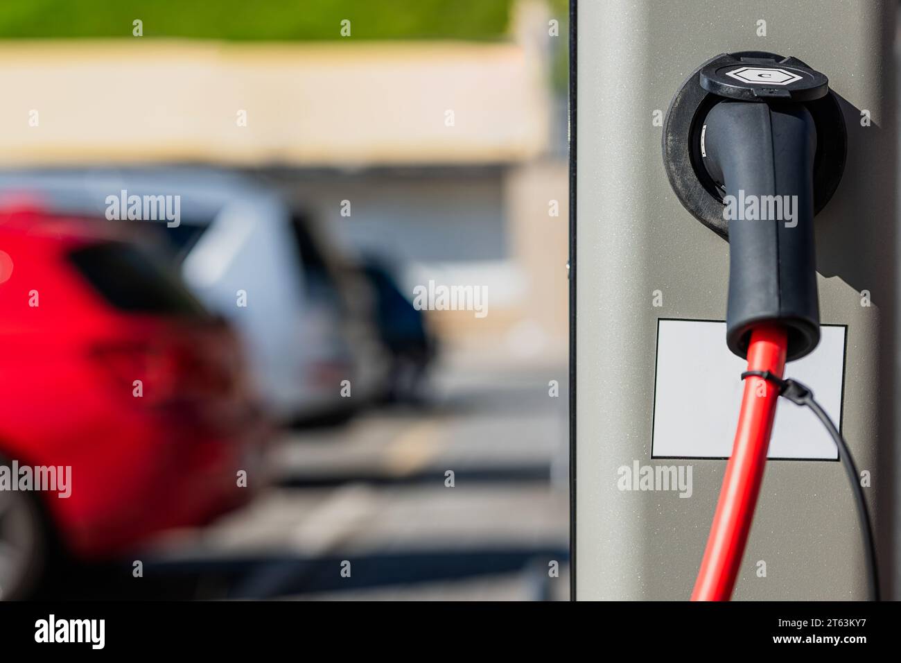 Contemporary public electric vehicle charging station with gun chargers ...