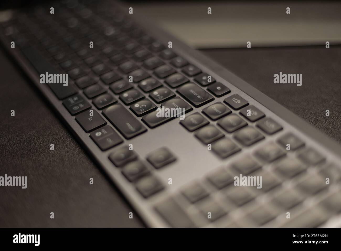 Close-up view of a sleek black computer keyboard with prominent keys ...