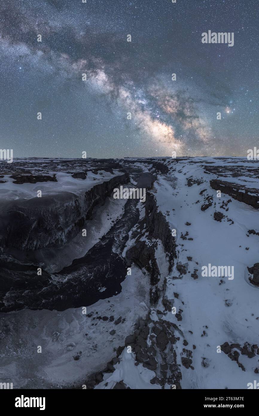 Expansive aerial shot capturing a snow-covered landscape dissected by a ...