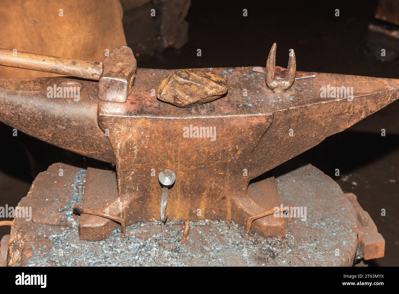 Close-up of a weathered anvil with a hammer tools and remnants of a ...