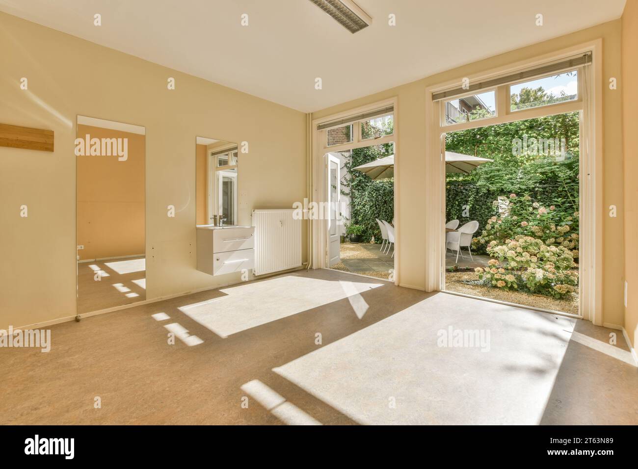 Sunlight falling on floor in unfurnished empty living room through ...