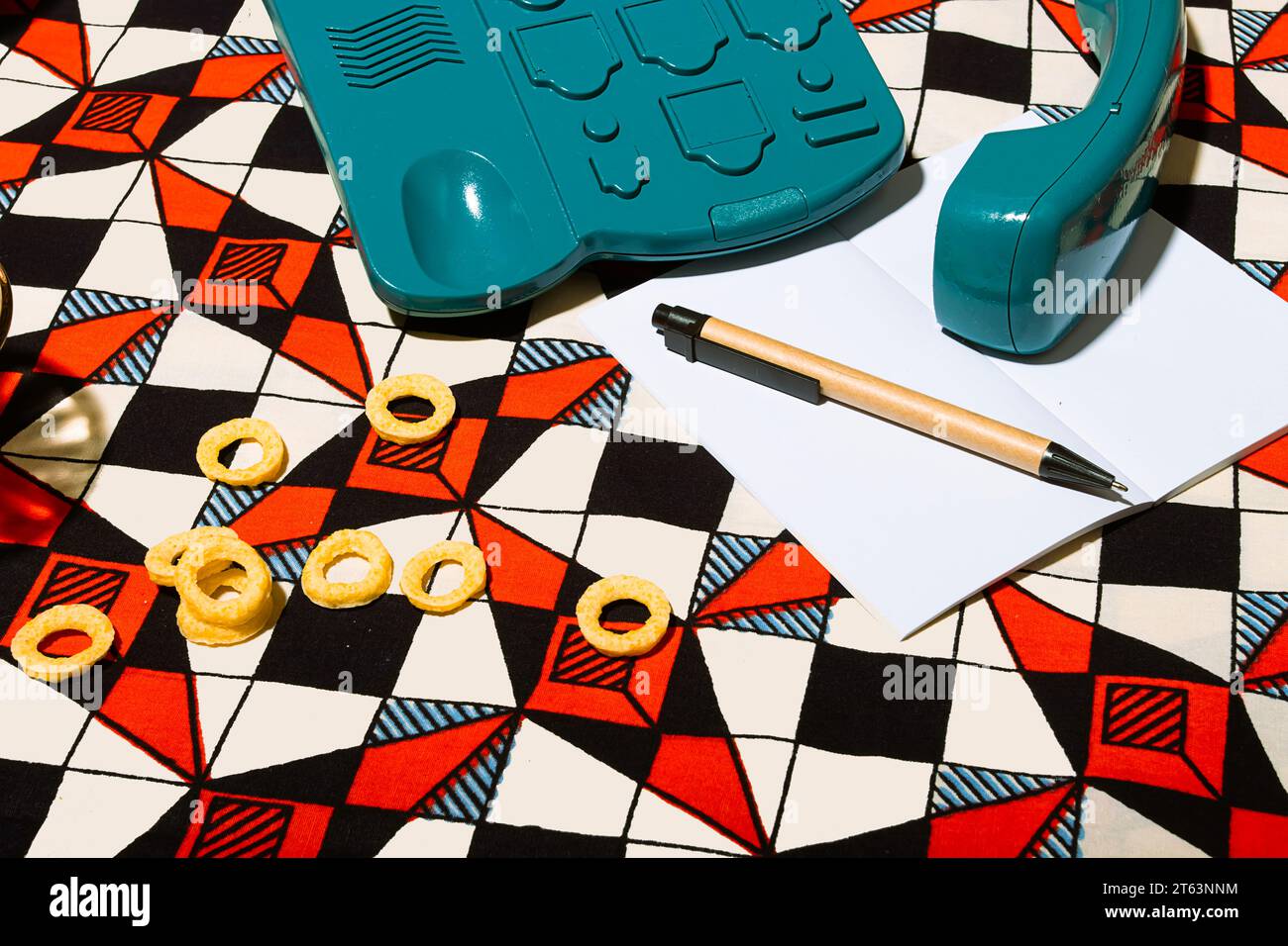 High angle of vintage turquoise telephone with its coiled cord ...