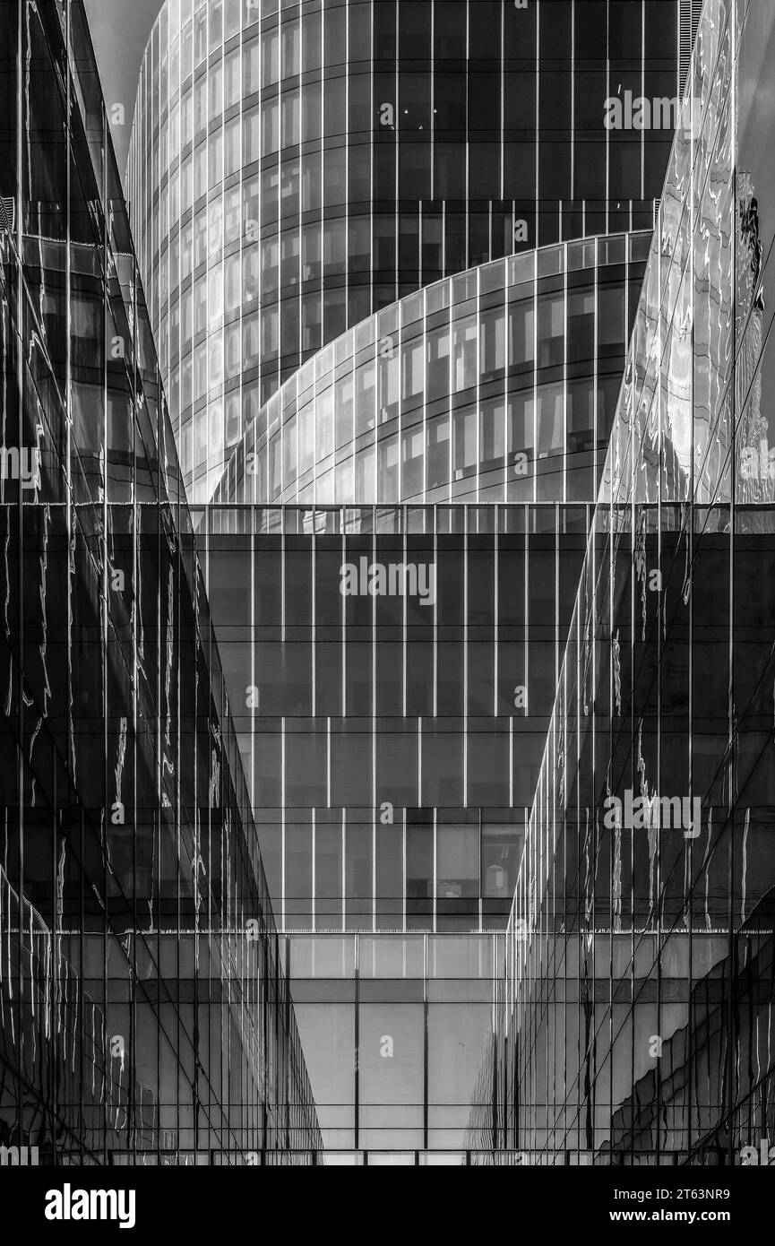 Modern glass office building with reflecting windows and curved ...