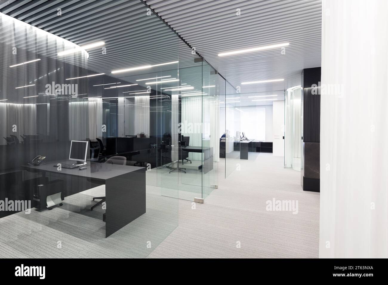 A modern office space featuring sleek design elements such as a dark ...
