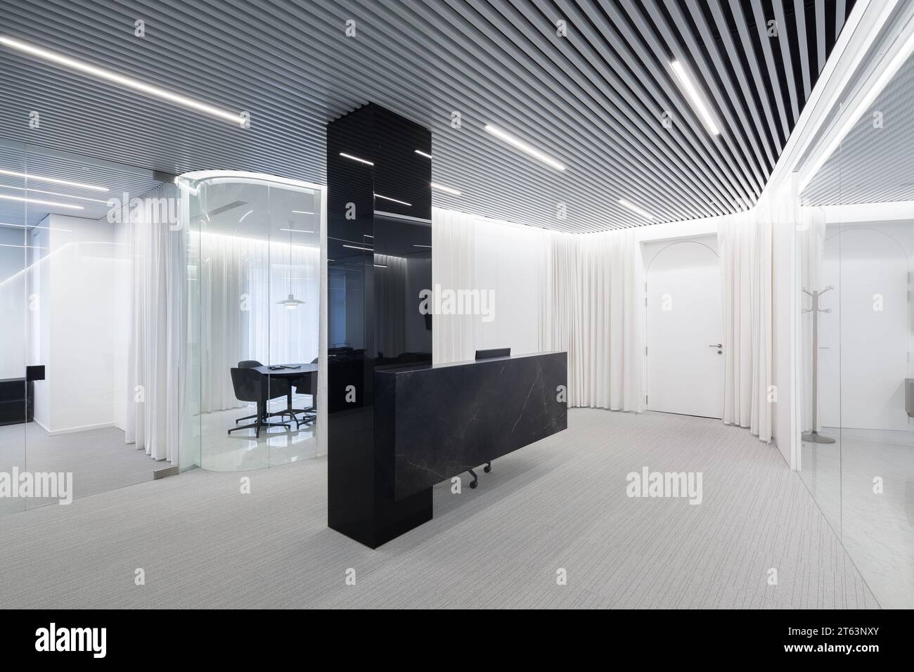 A spacious, modern office area showcasing a translucent partition, a ...