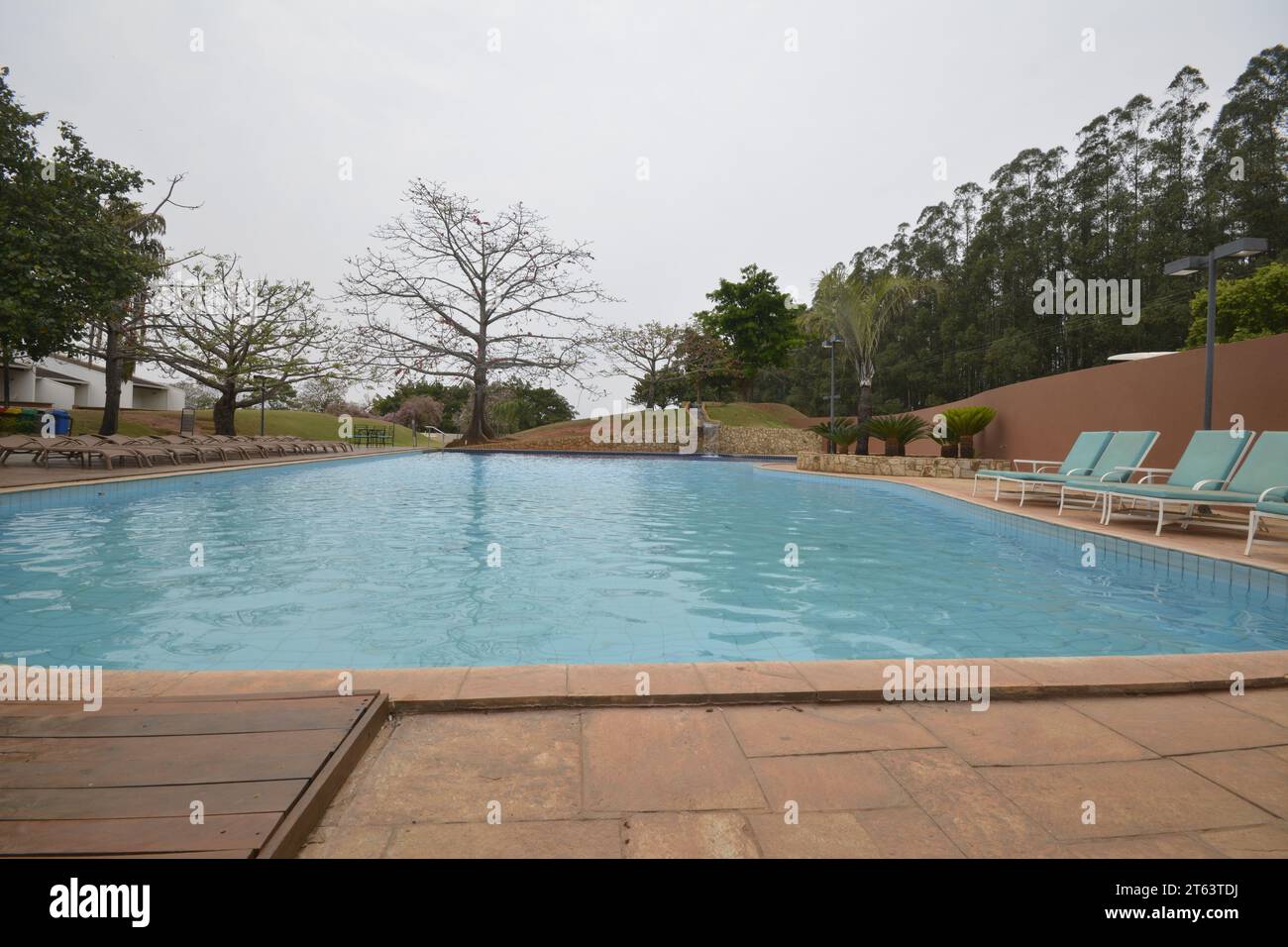 Luxury resort pool with stone waterfall in the background and sun ...
