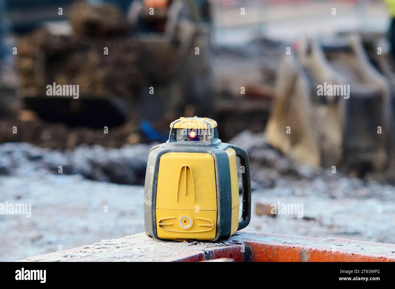 Rotating laser surveying equipment at building construction site with ...