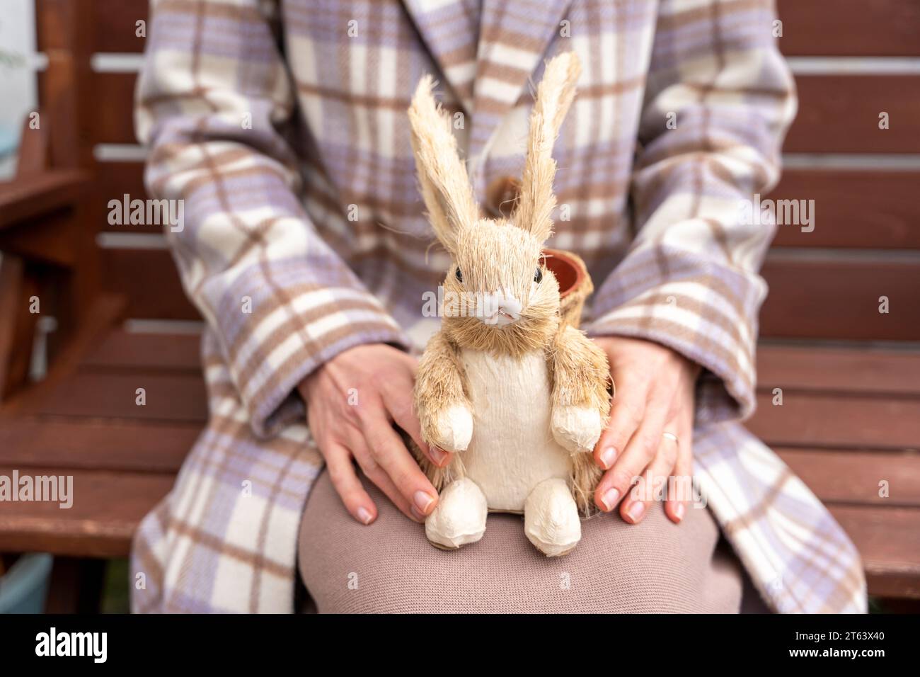 woman holding the easter bunny and seating on the bench Stock Photo - Alamy