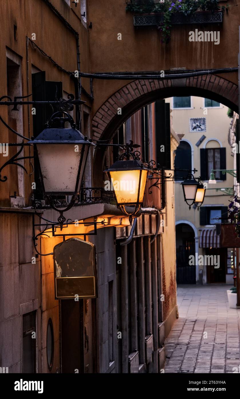 Street Lights line a dark alley in the city of Venice, Italy Stock ...