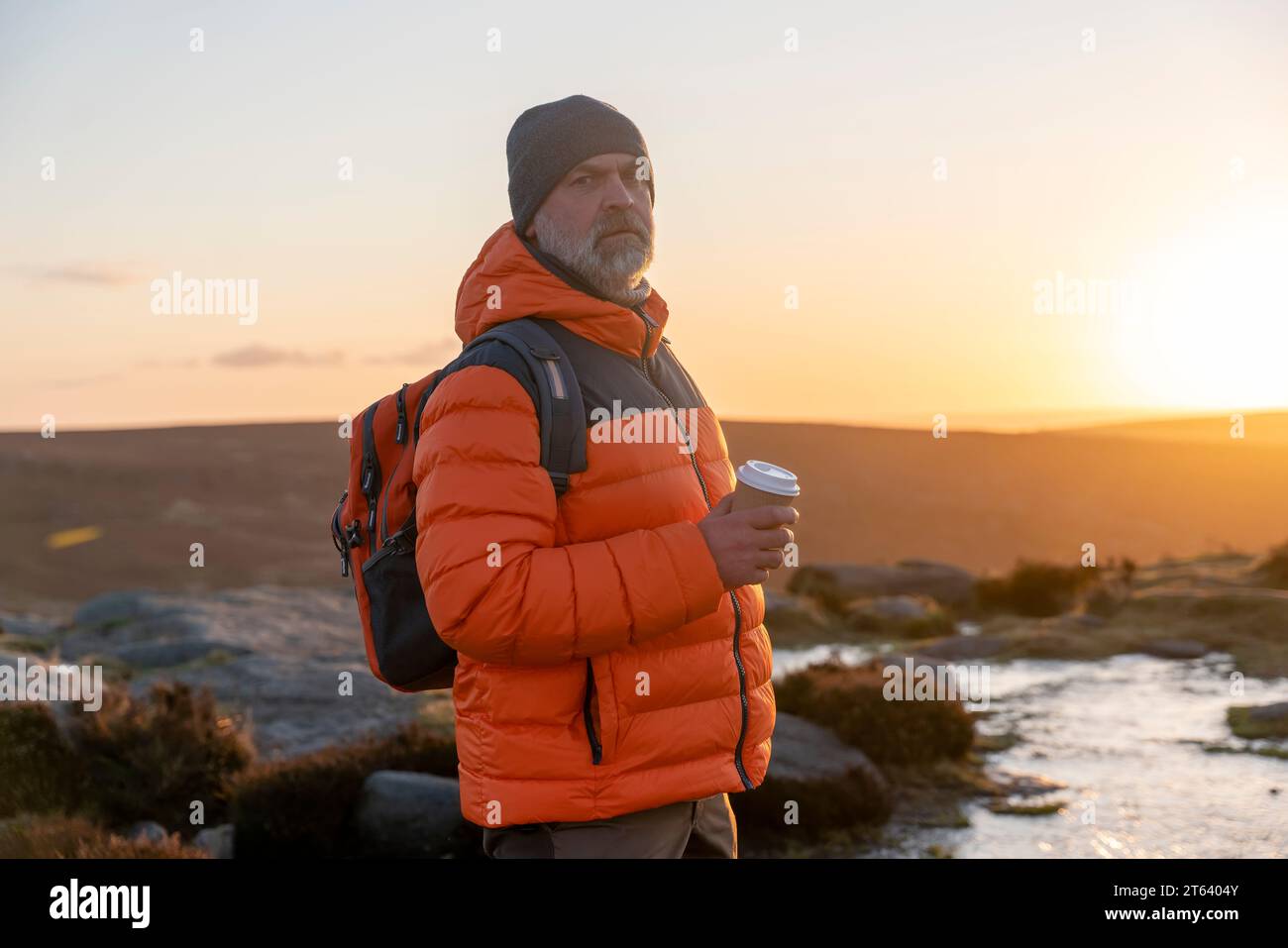 Bearded Man reaching the destination and on the top of a mountain at ...