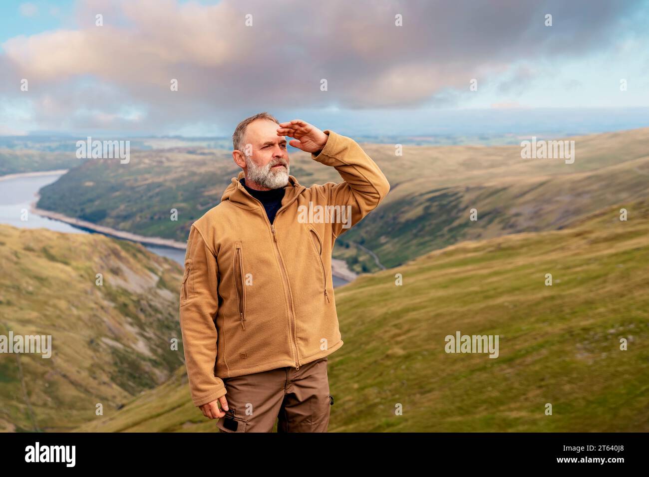 Bearded Man reaching the destination and on the top of mountain at ...