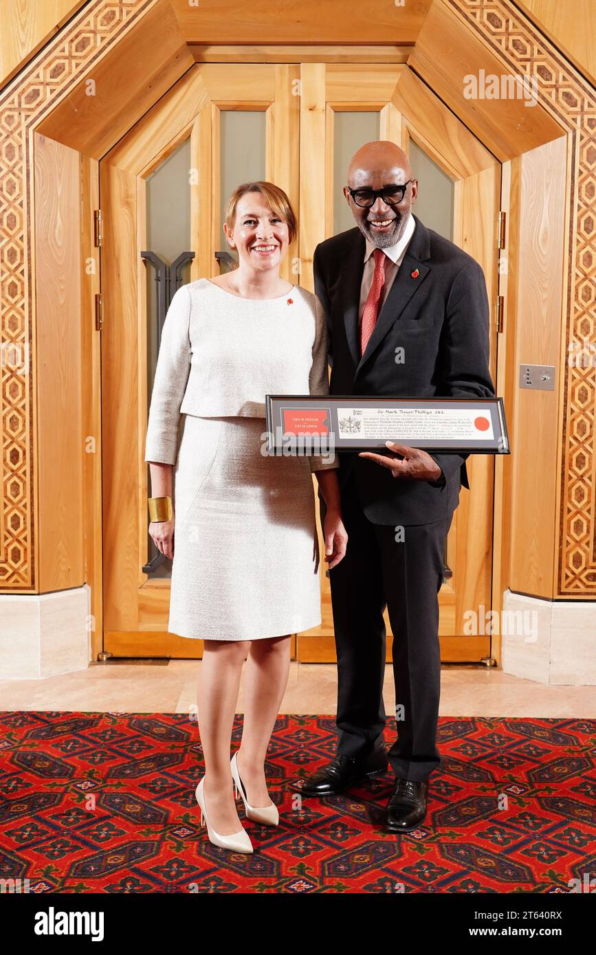 Helen Veale (left) with husband Sir Trevor Phillips as he is granted ...