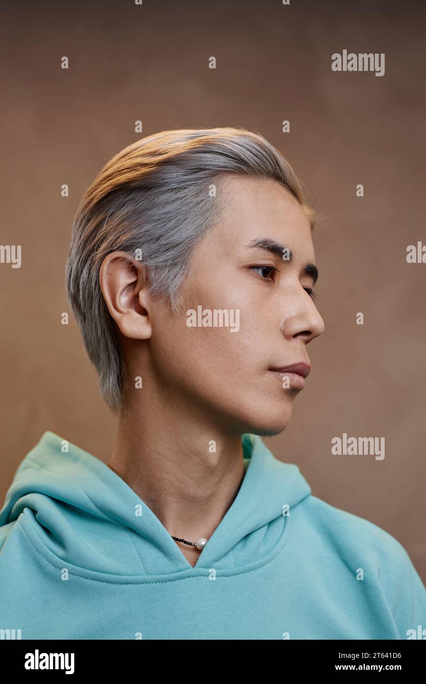 Side view closeup portrait of young Asian man with modern mens ...