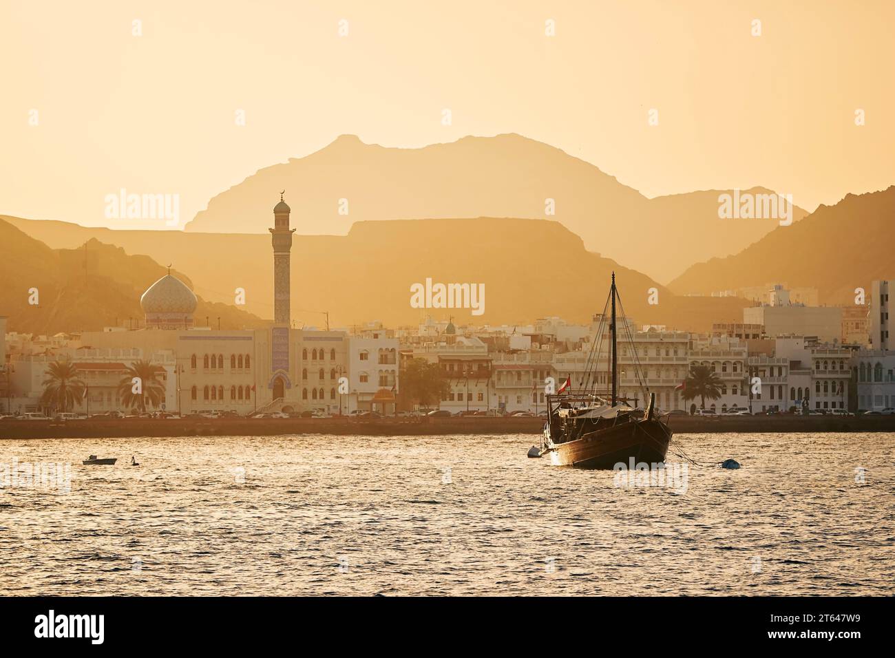 Harbor with traditional wooden boat Dhow and waterfront of old town in ...